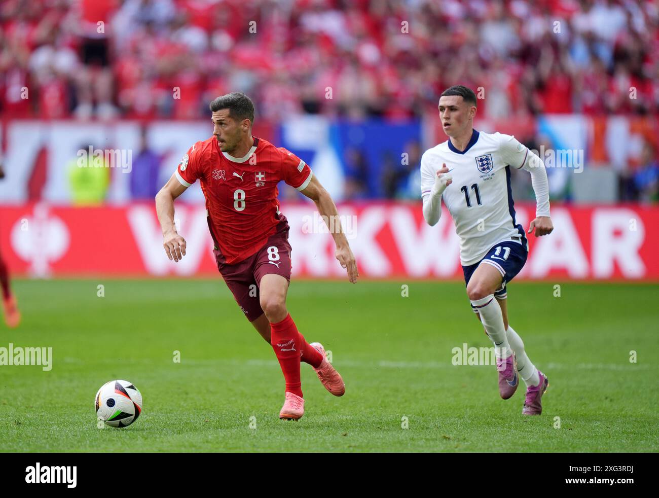Switzerland's Remo Freuler (left) and England's Phil Foden battle for ...