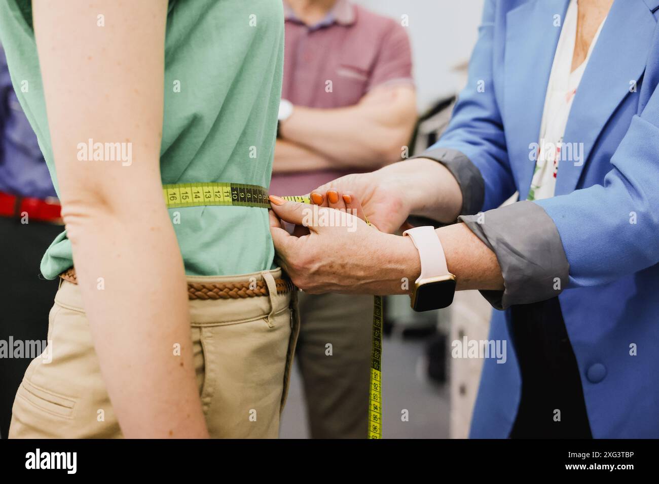 Close up of a woman measuring in a weight control Stock Photo - Alamy