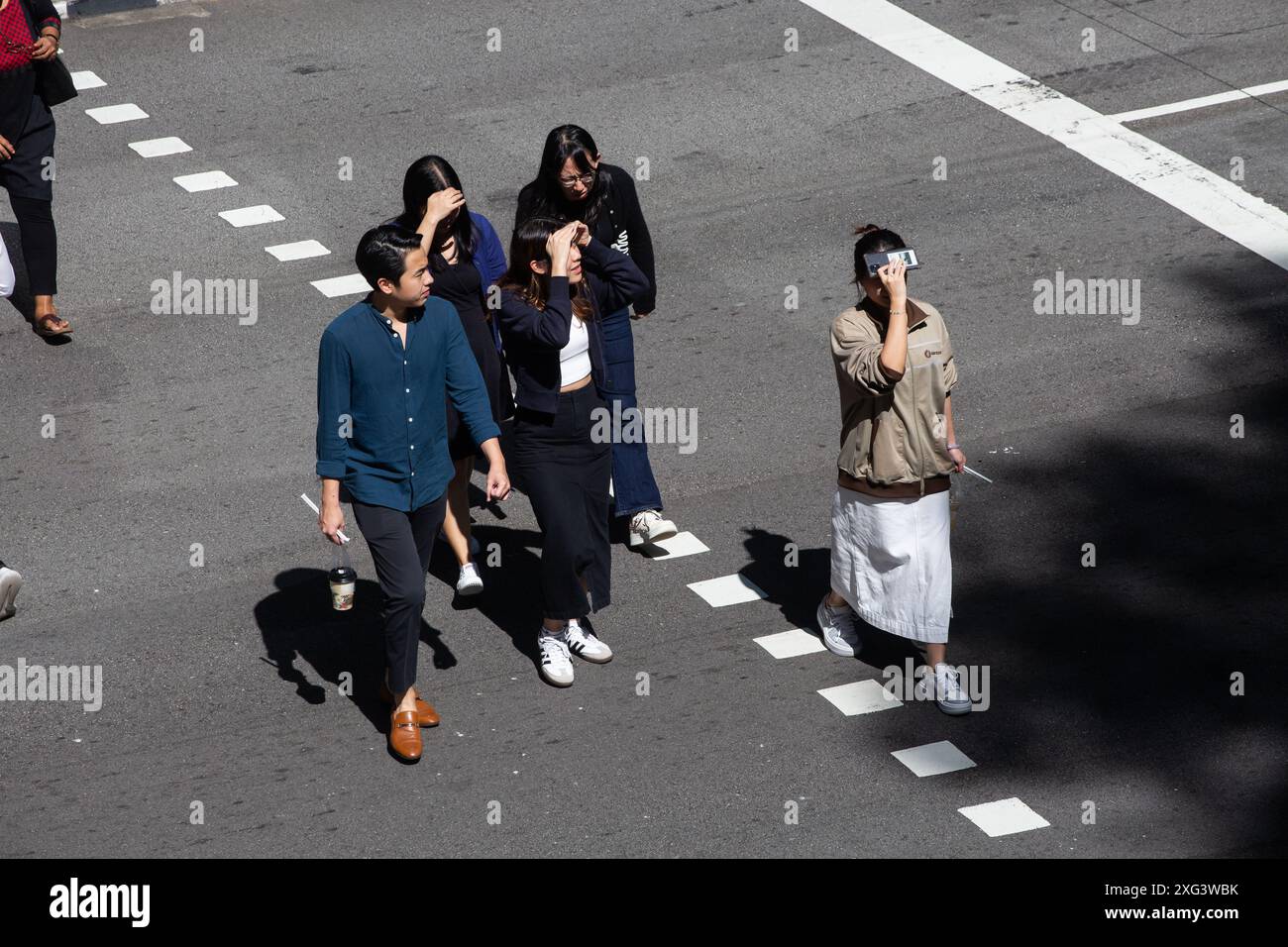 Women use their arm hand to shield their faces from the overpowering ...