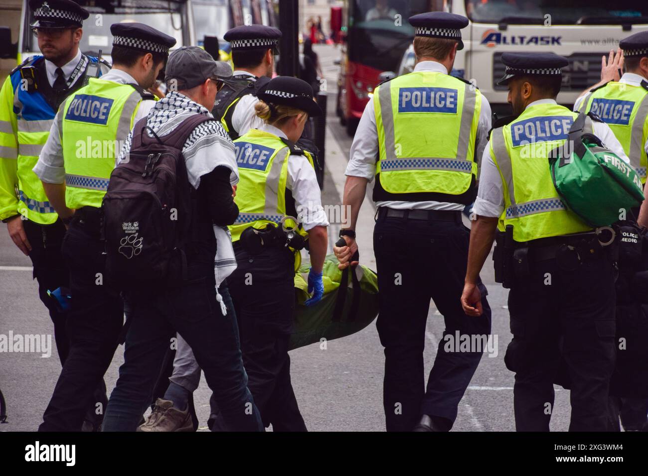 July 6, 2024, London, England, UK: Police officers carry a protester ...