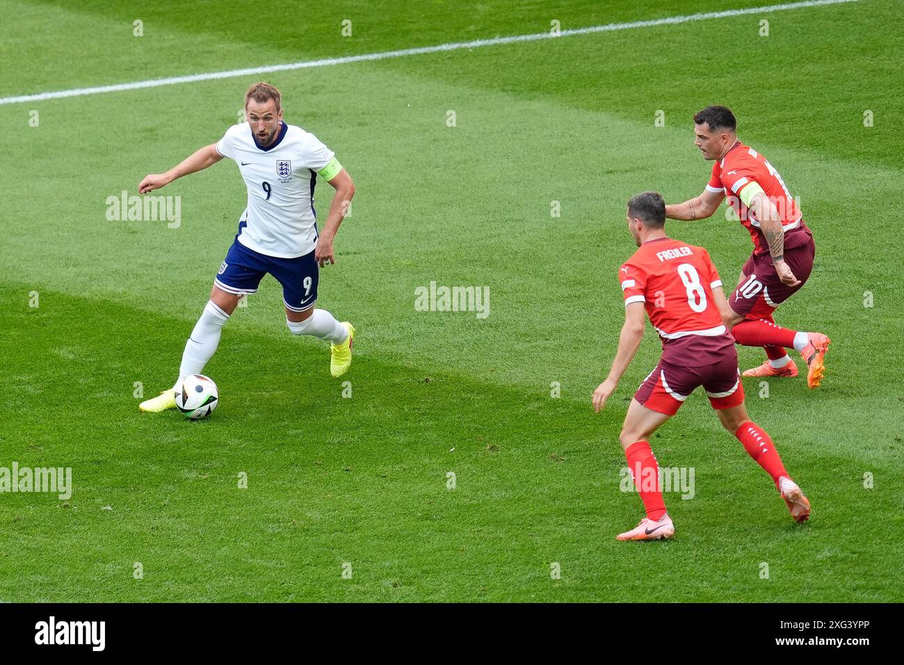 England's Harry Kane (left) in action with Switzerland's Remo Freuler ...