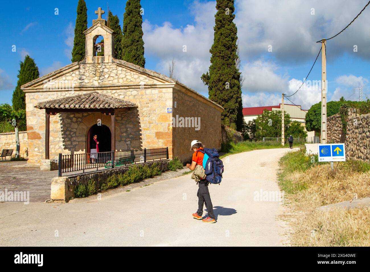 Pilgrims walking the camino de Santiago passing The hermitage of Our ...