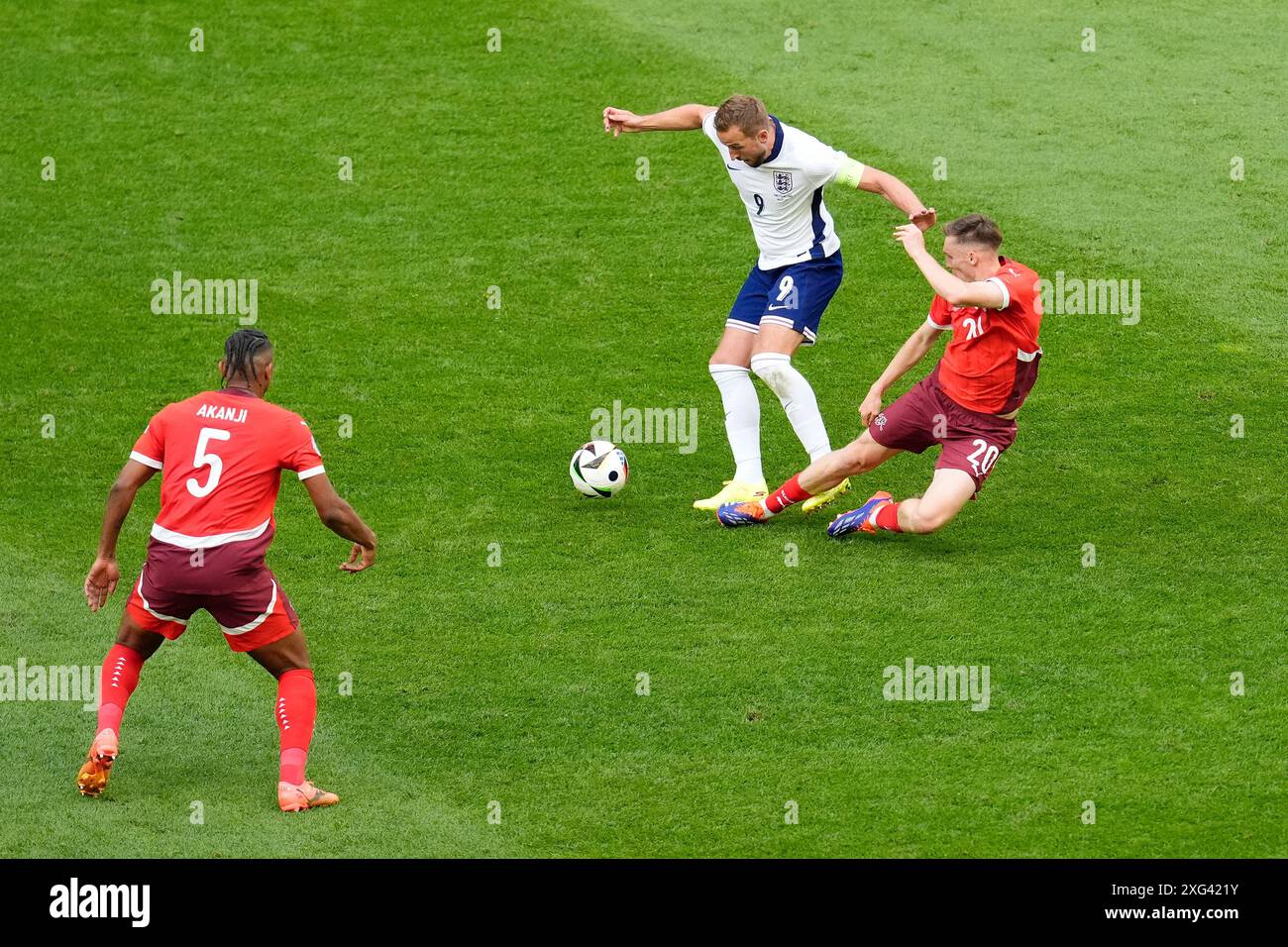 England's Harry Kane (centre) is tackled by Switzerland's Michel ...