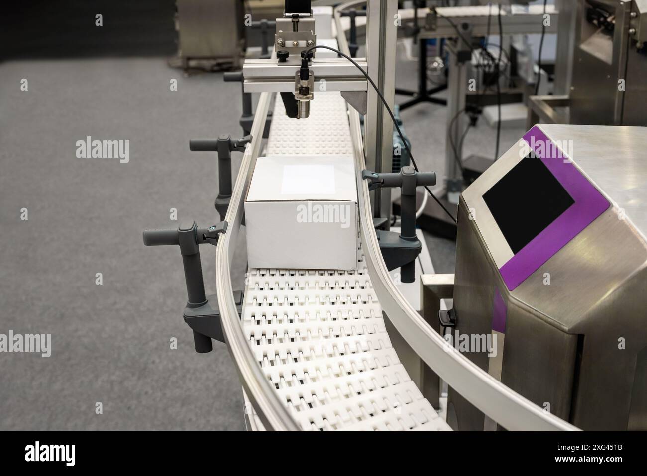 White cardboard box on the production line of a packaging and ...