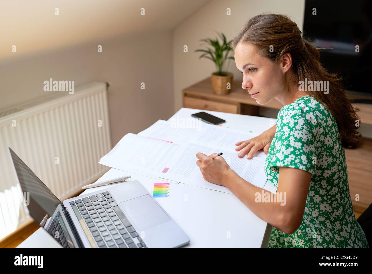 E-learning and continuing education. Female adult student studying at ...