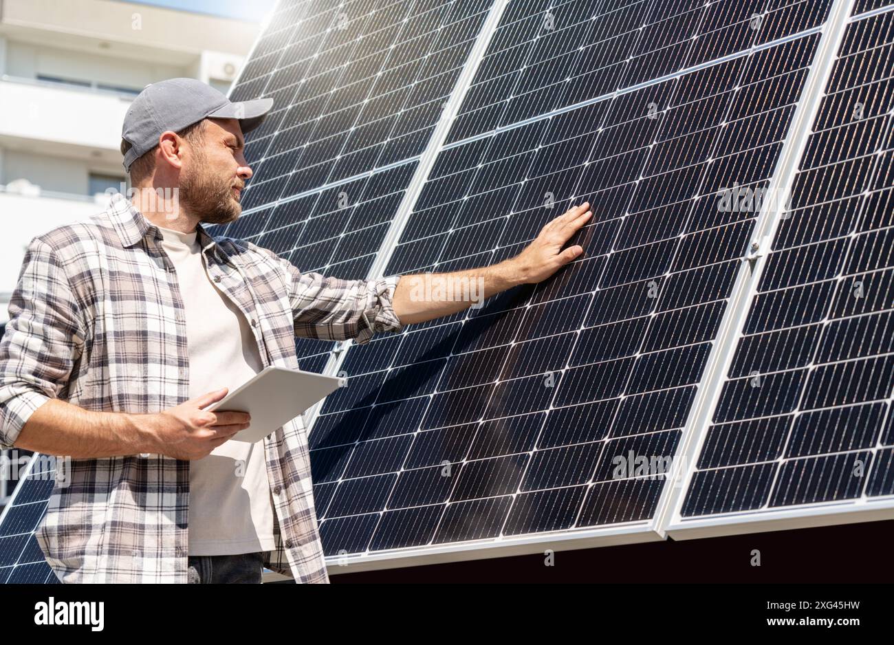 Man solar panel maintenance specialist with digital tablet touching ...