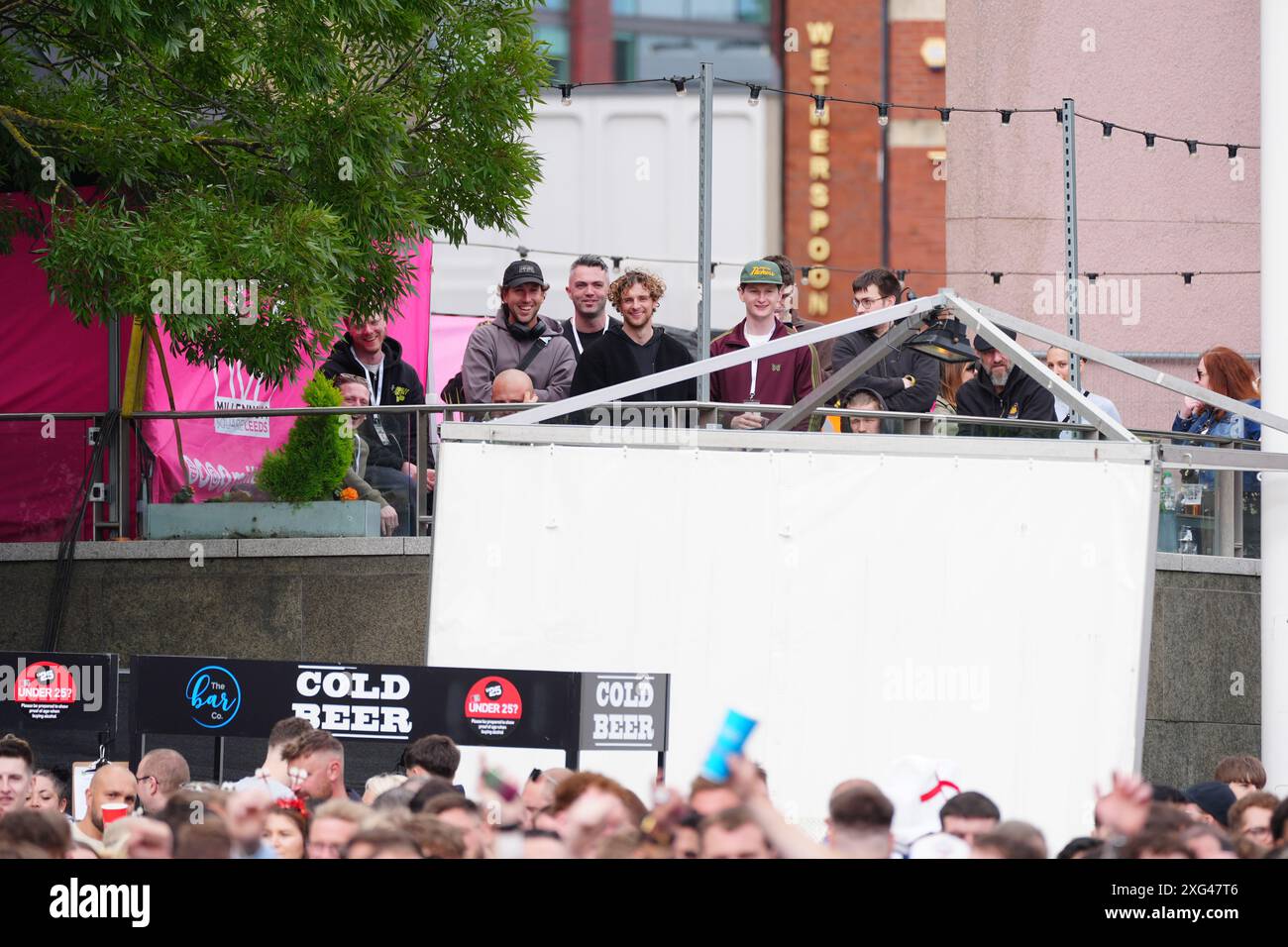 Singer Tom Grennan (at back) in Millennium Square in Leeds during a ...