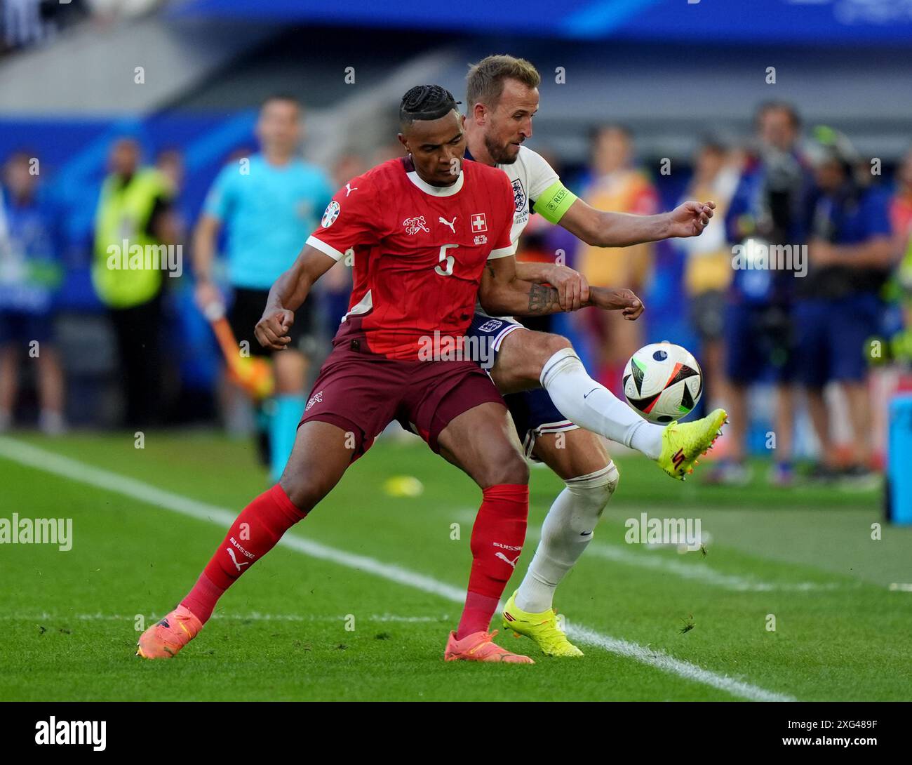 Switzerland's Manuel Akanji (left) and England's Harry Kane battle for ...