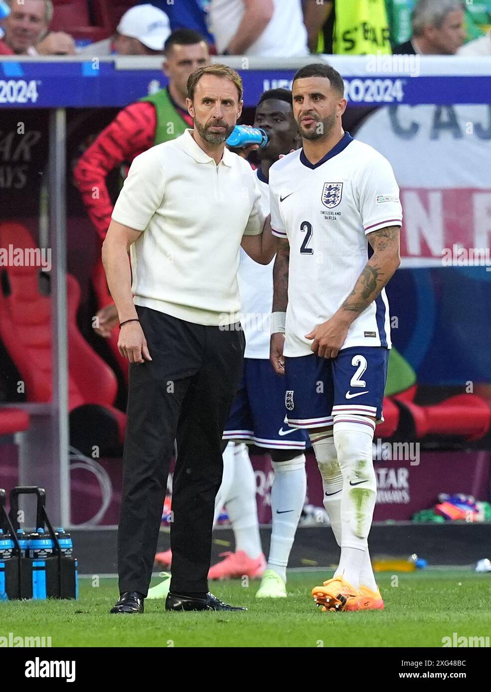 England manager Gareth Southgate (left) speaks with player Kyle Walker ...