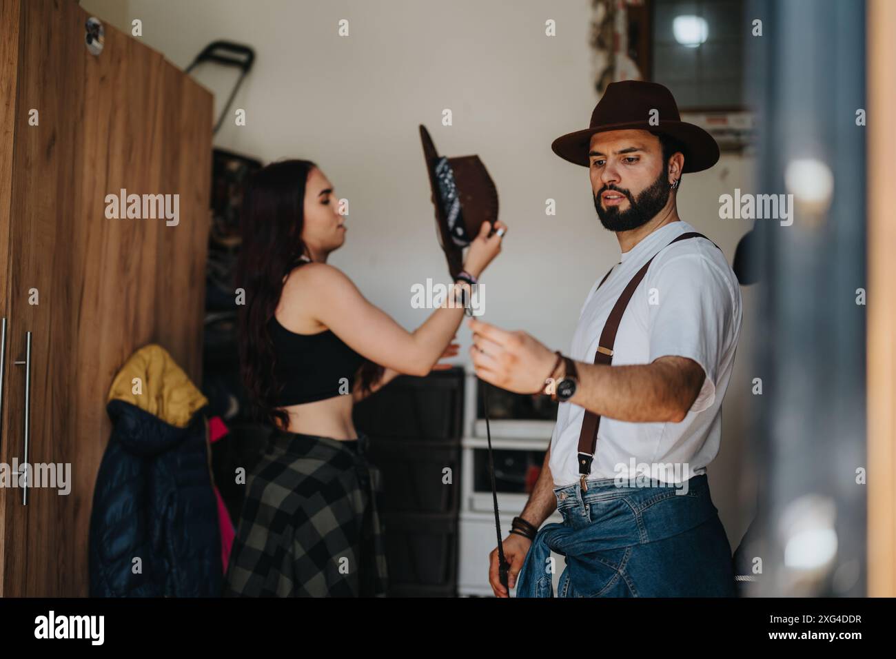 Couple dressing up in western attire with hats and suspenders Stock ...