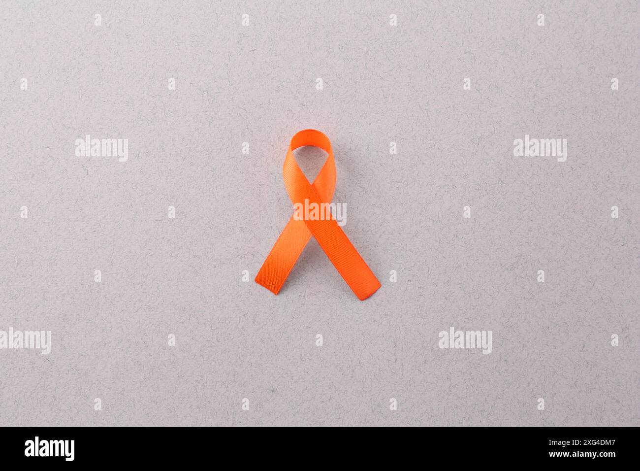 Orange awareness ribbon on gray background, top view Stock Photo - Alamy