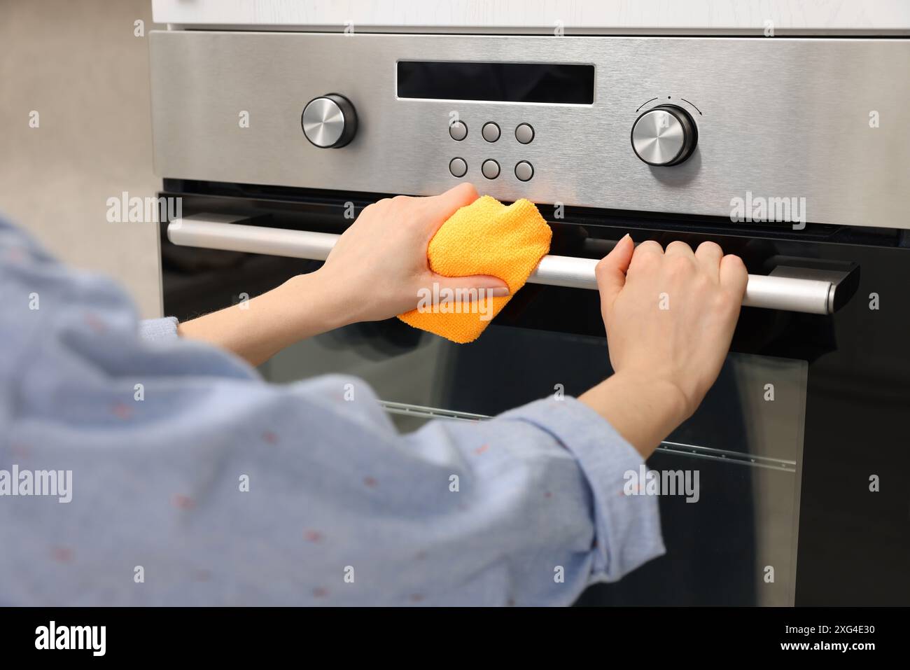 Woman cleaning electric oven with rag in kitchen, closeup Stock Photo ...