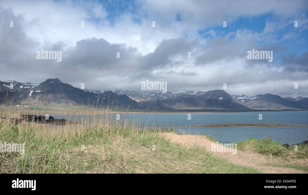 Panoramic coastline with black lava rocks and bright sand at Budir Bay ...
