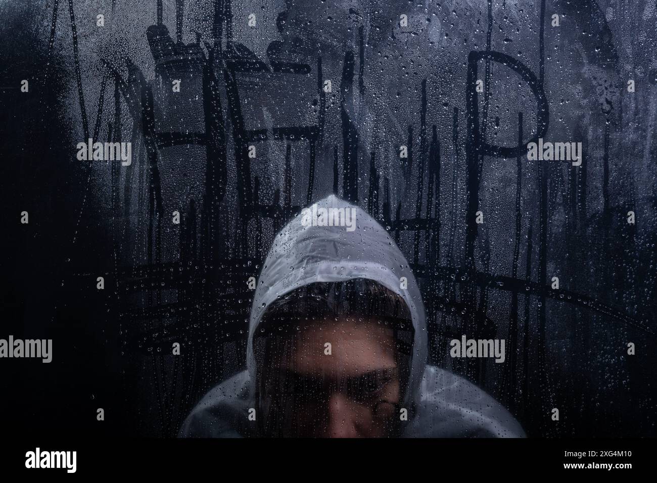 The word help written on a transparent glass wet with water drops ...