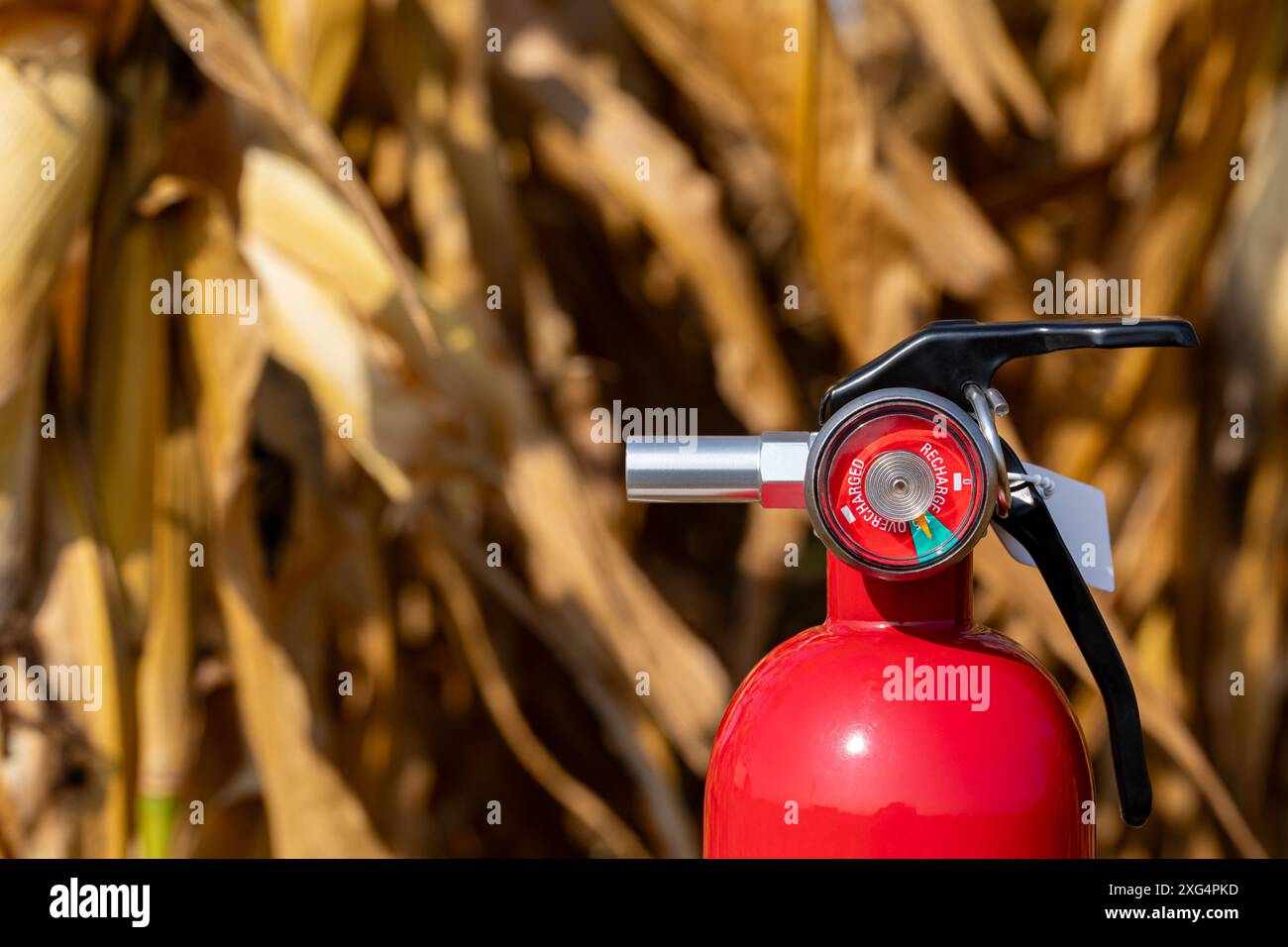 Fire extinguisher in cornfield during harvest. Farm safety, fire safety ...