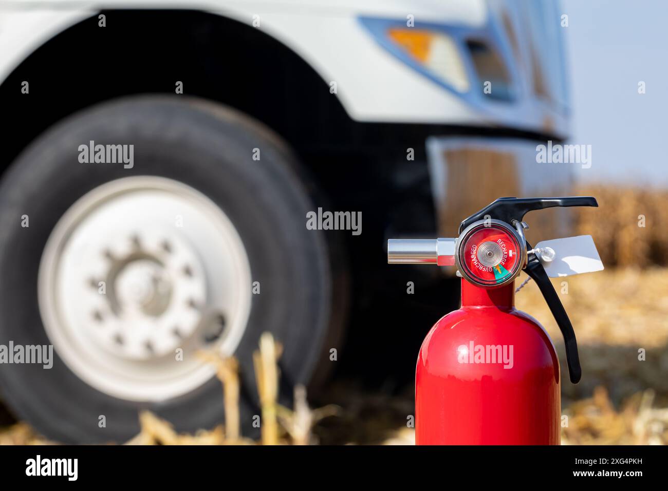Fire extinguisher and grain truck in cornfield during harvest. Farm ...