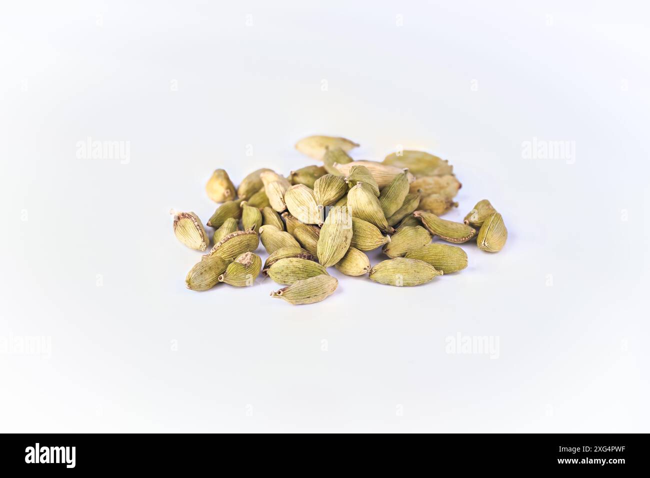 pile of cardamone seeds isolated on white background Stock Photo - Alamy