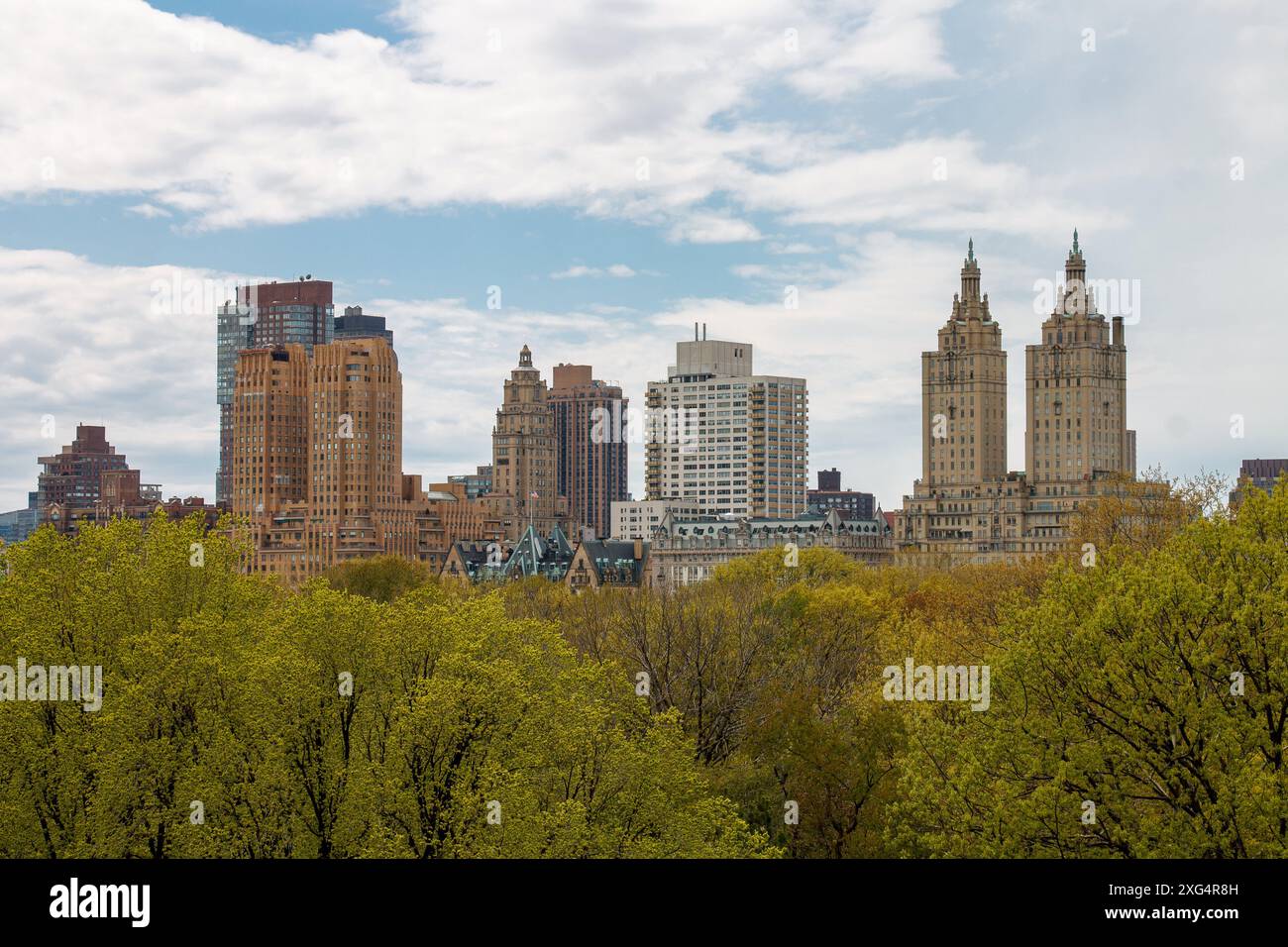 The skyline of the skyscrapers of Manhattan Island over the trees of ...