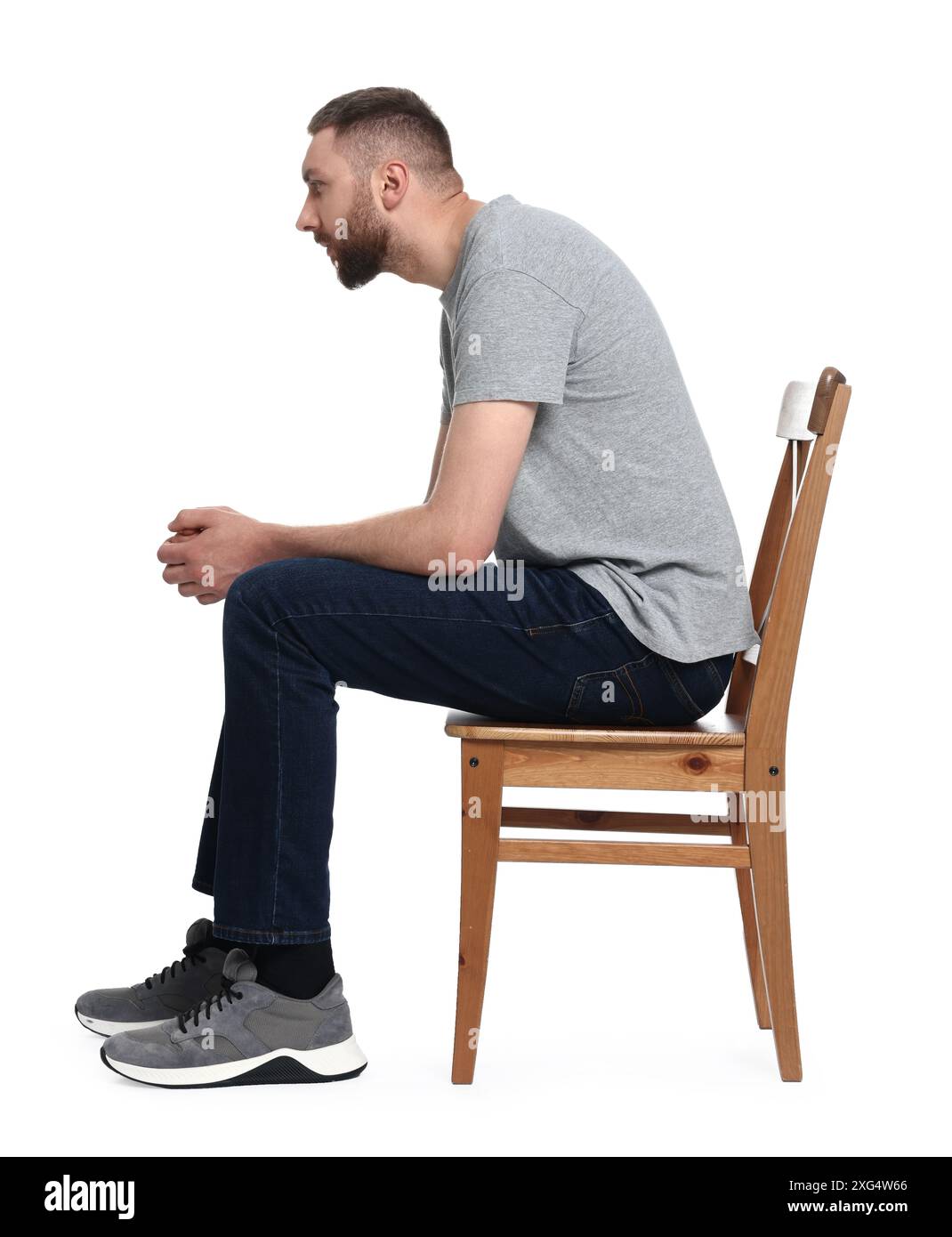 Man with poor posture sitting on chair against white background Stock ...