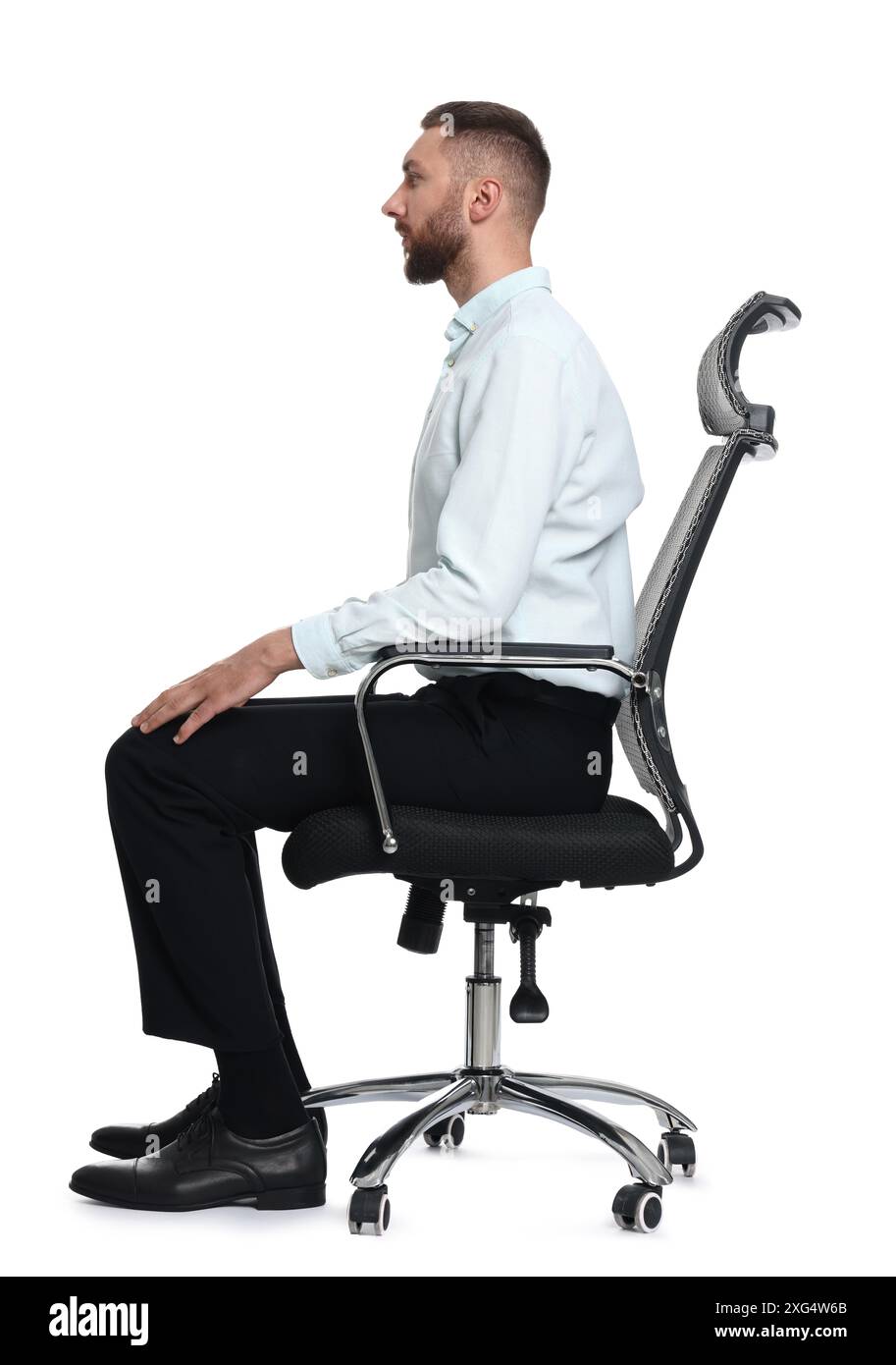 Man with good posture sitting on chair against white background Stock ...