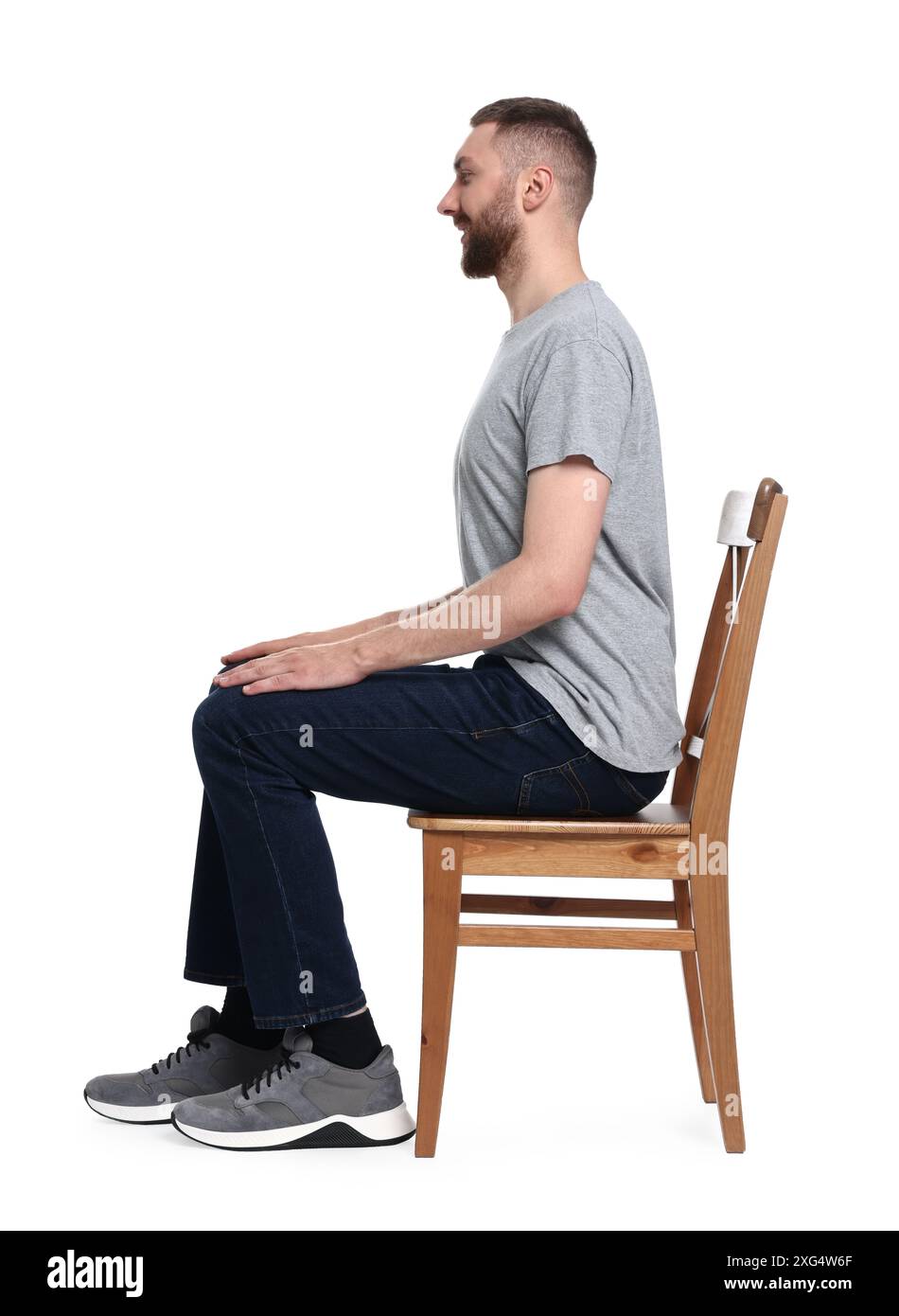 Man with good posture sitting on chair against white background Stock ...
