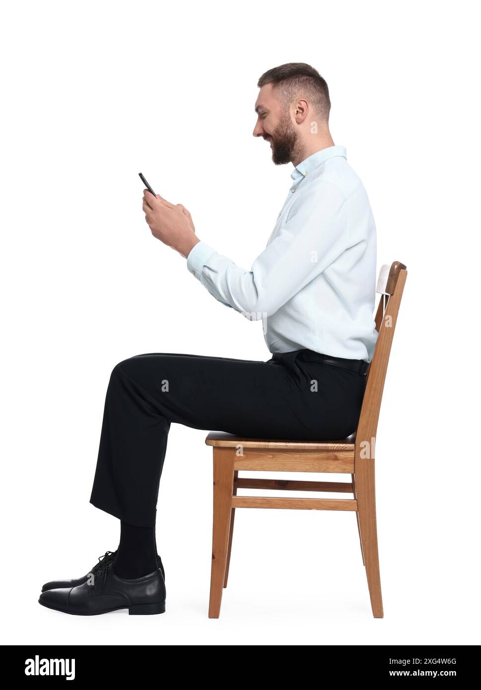 Man with good posture sitting on chair and using smartphone against ...