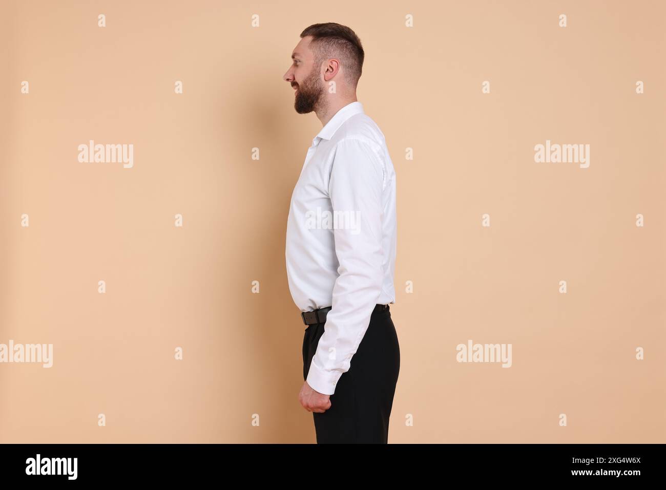 Man with good posture on pale orange background Stock Photo - Alamy