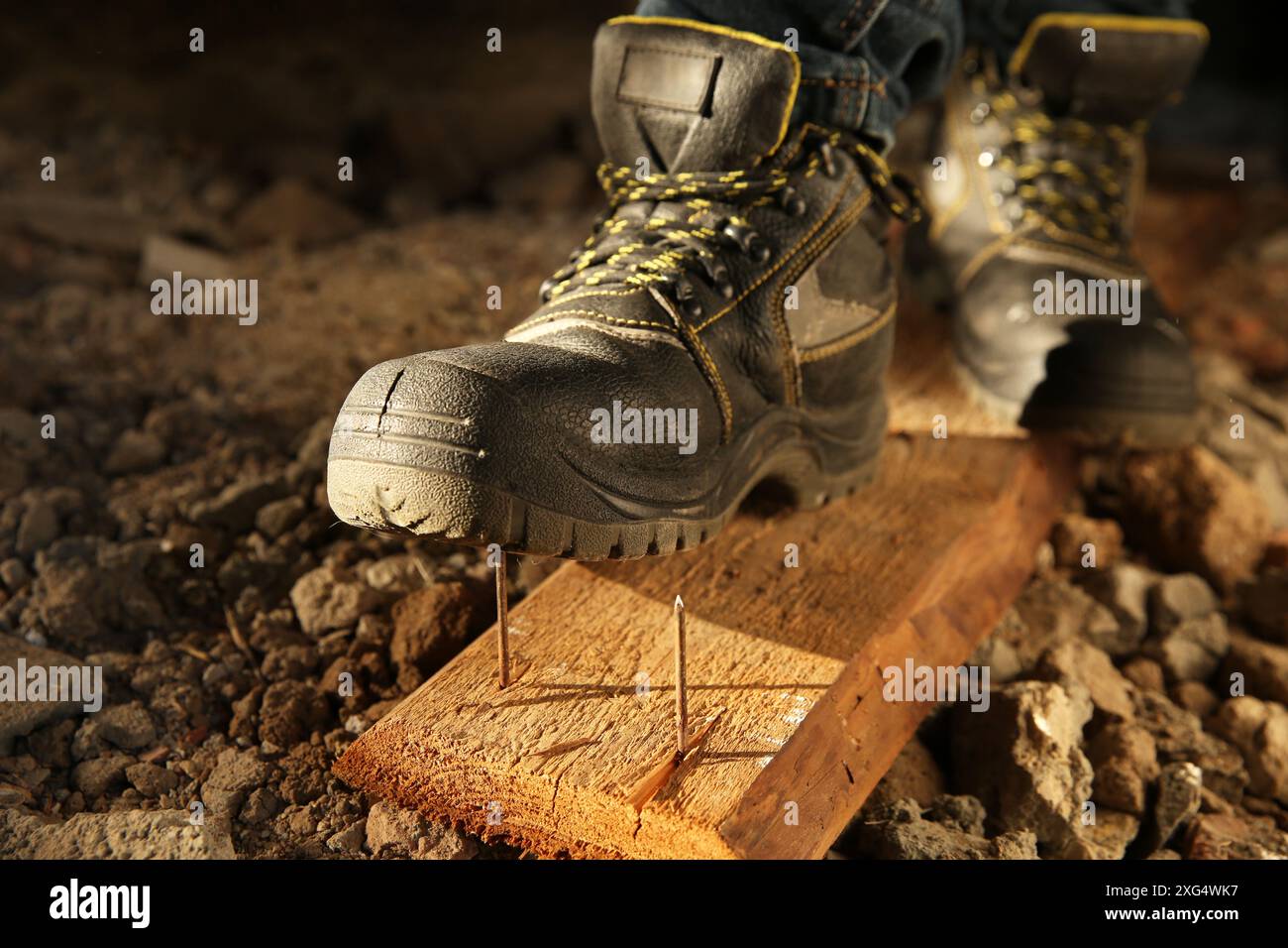 Careless worker stepping on nails in wooden plank, closeup Stock Photo ...