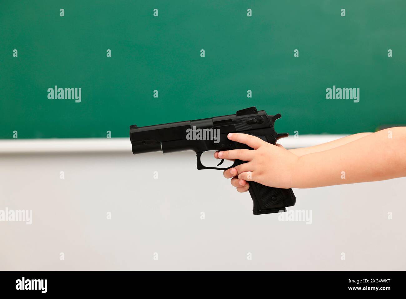 Child with gun in classroom, closeup. School shooting Stock Photo - Alamy