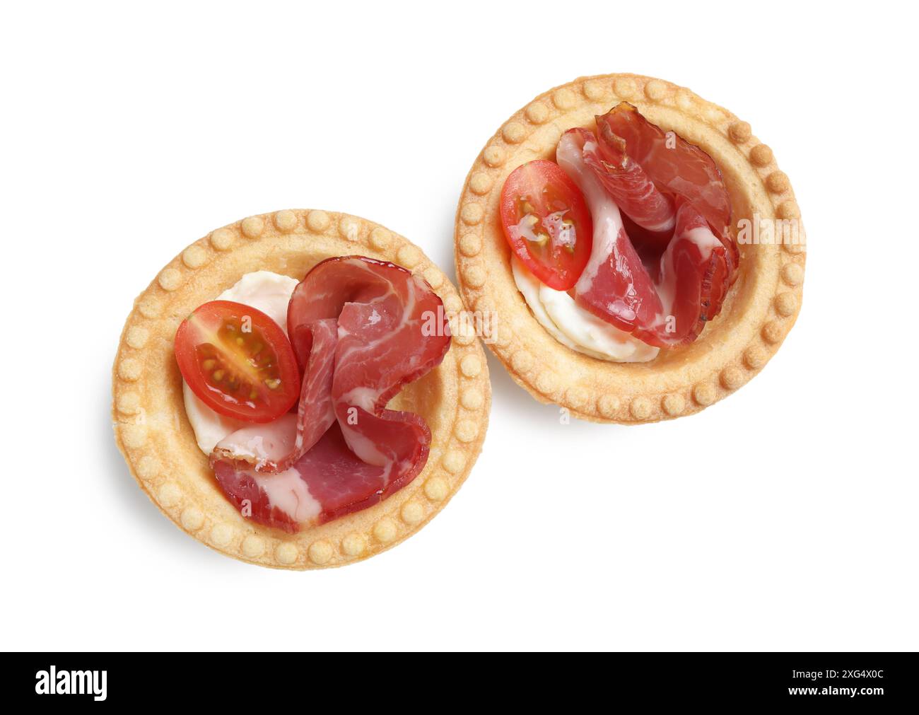 Delicious canapes with jamon, cream cheese and cherry tomatoes isolated ...