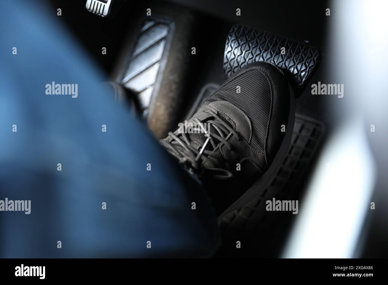 Man pushing on pedal of car brake, closeup Stock Photo - Alamy