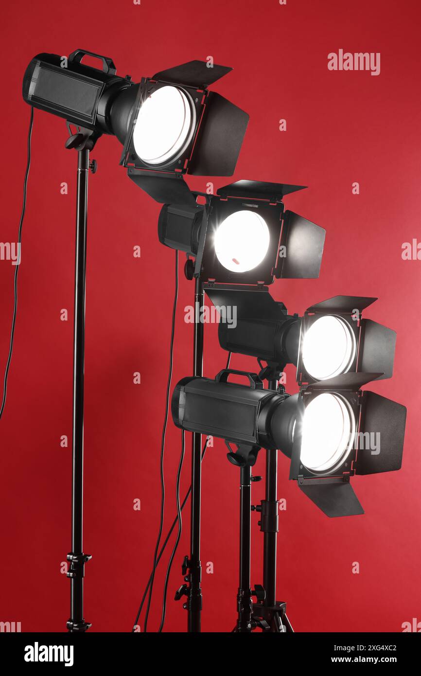 Red photo background and professional lighting equipment in studio ...