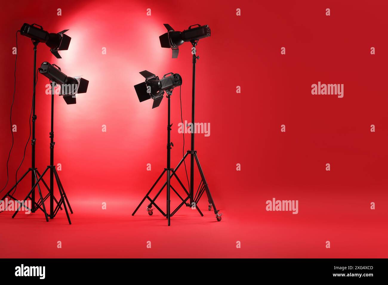 Red photo background and professional lighting equipment in studio ...
