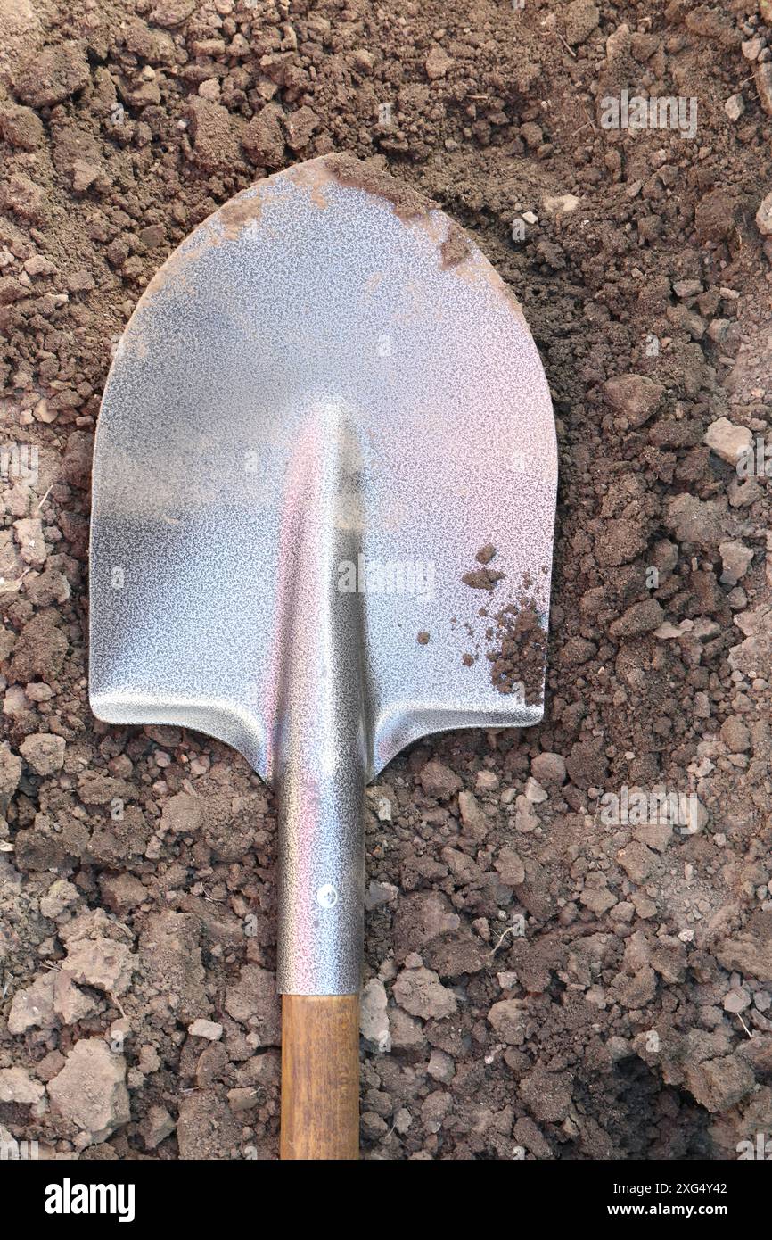 Metal shovel on soil outdoors, top view Stock Photo - Alamy