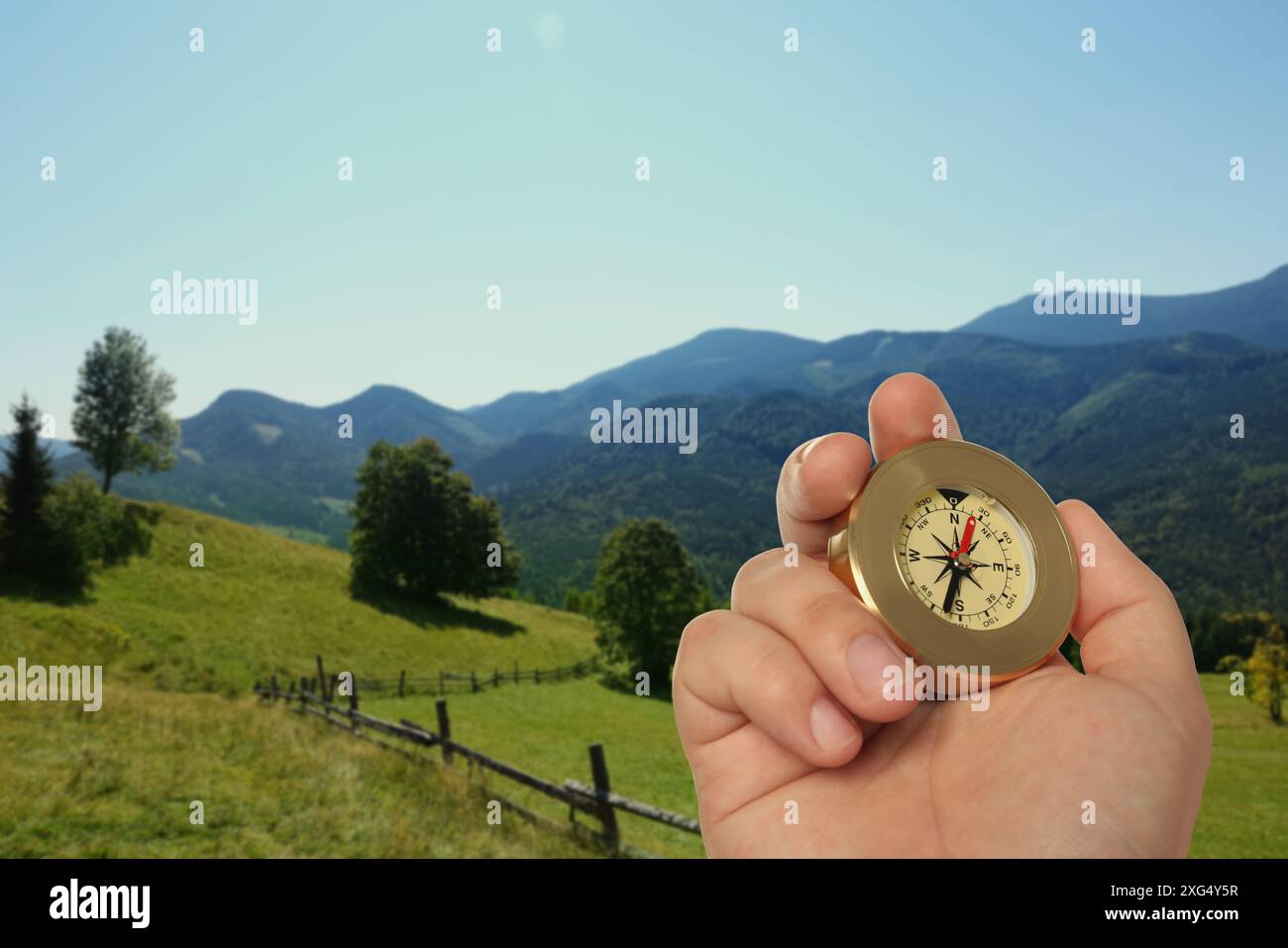 Man using compass in mountains, closeup. Navigational instrument Stock ...