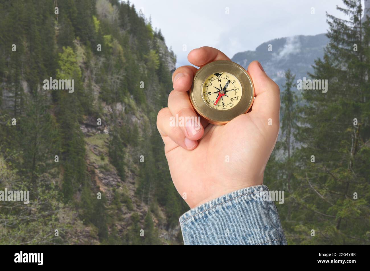 Man using compass in mountains, closeup. Navigational instrument Stock ...