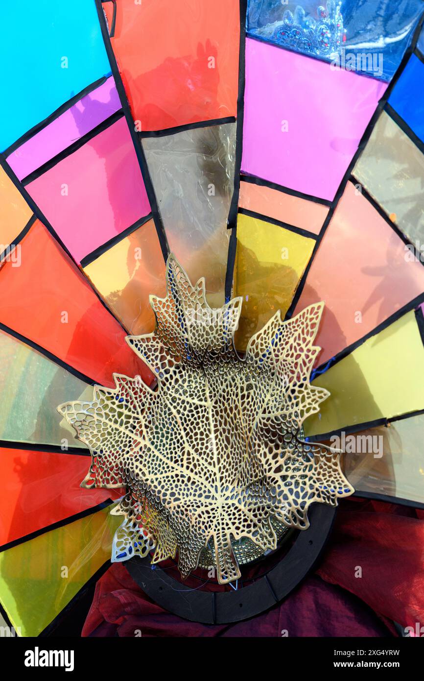 Artistic stained glass window with colorful panels and central metallic ...