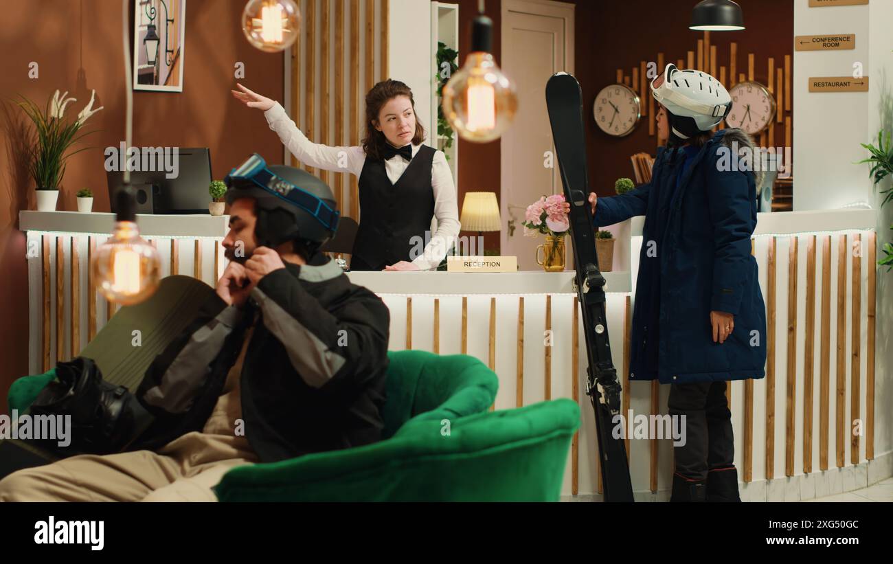 Receptionist giving directions asian guest hi-res stock photography and ...