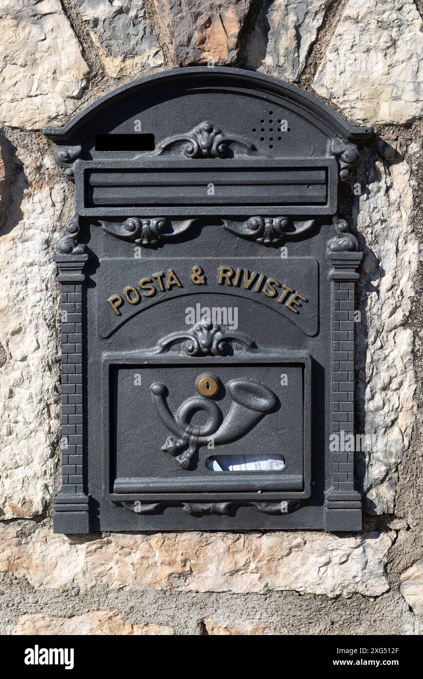 MALCESINE, ITALY - JUNE 12, 2024: Ornate grey post box set in stone ...
