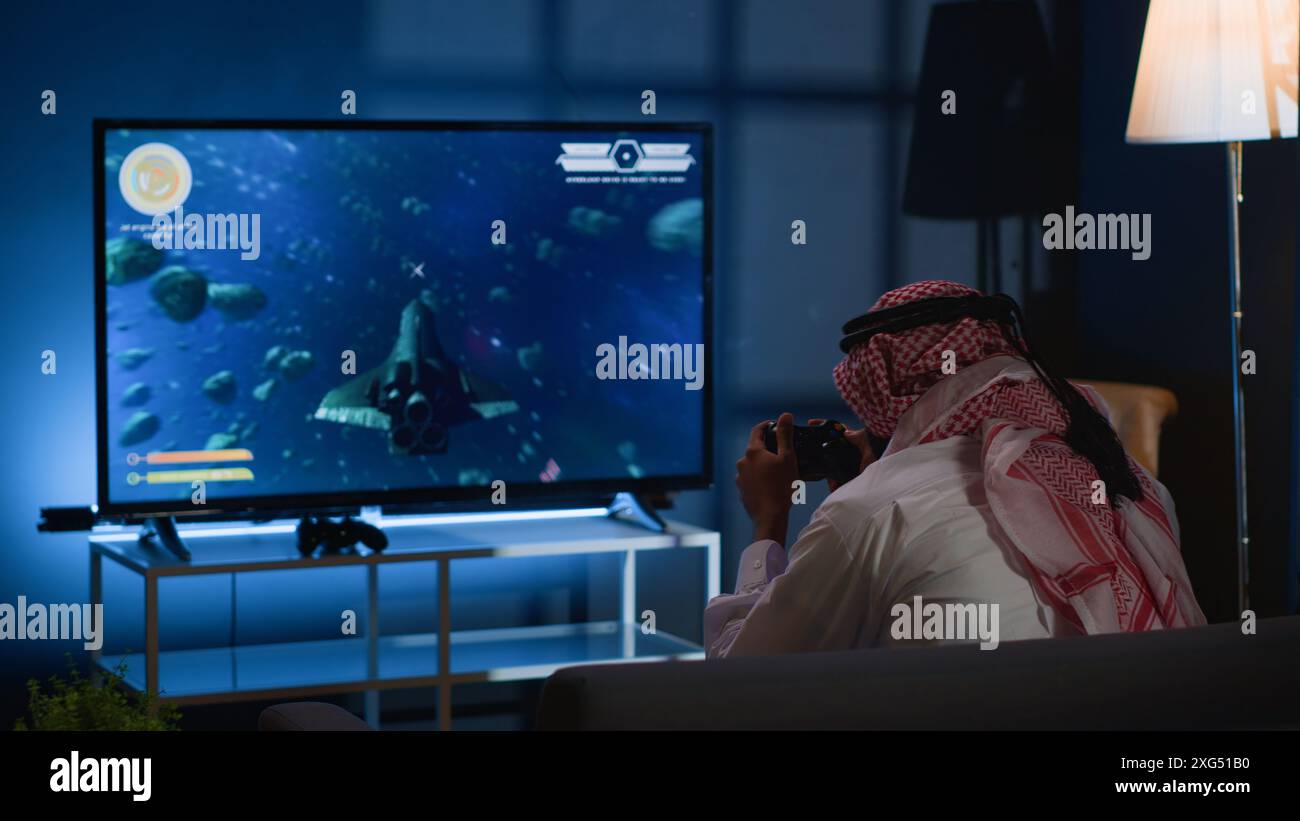 Arabic gamer playing classic arcade action videogame, flying through ...