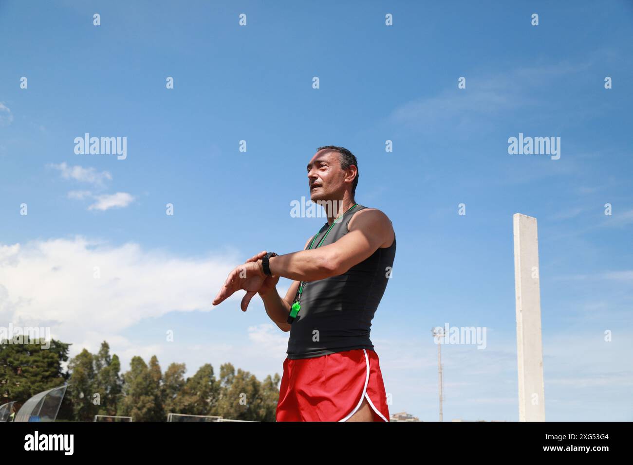 Hand Of A Coach Holding A Stopwatch Stock Photo - Alamy