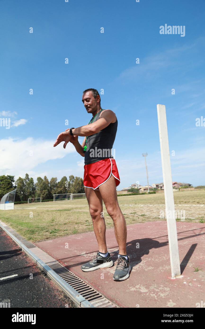 Coach Checking Time On His Smartwatch Stock Photo - Alamy