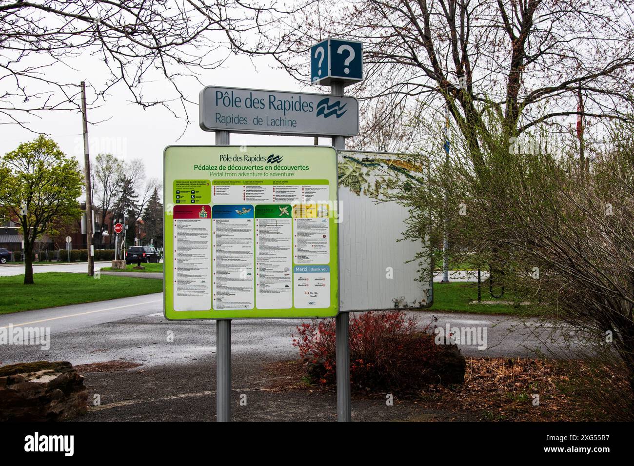 Pole of information signs showing amenities and services in and around ...