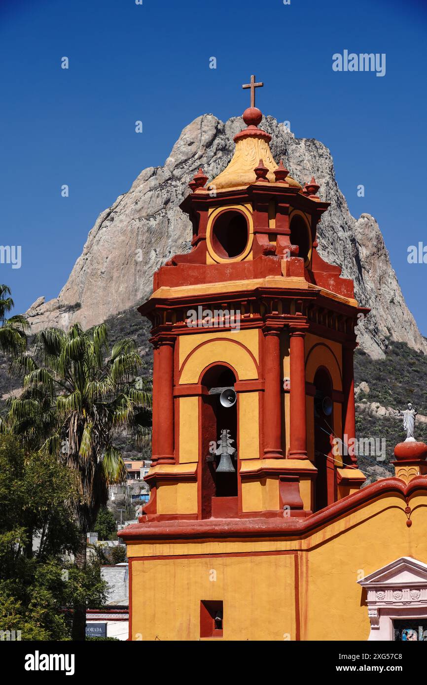 The Parroquia San Sebastian church with the massive Pena de Bernal rock ...