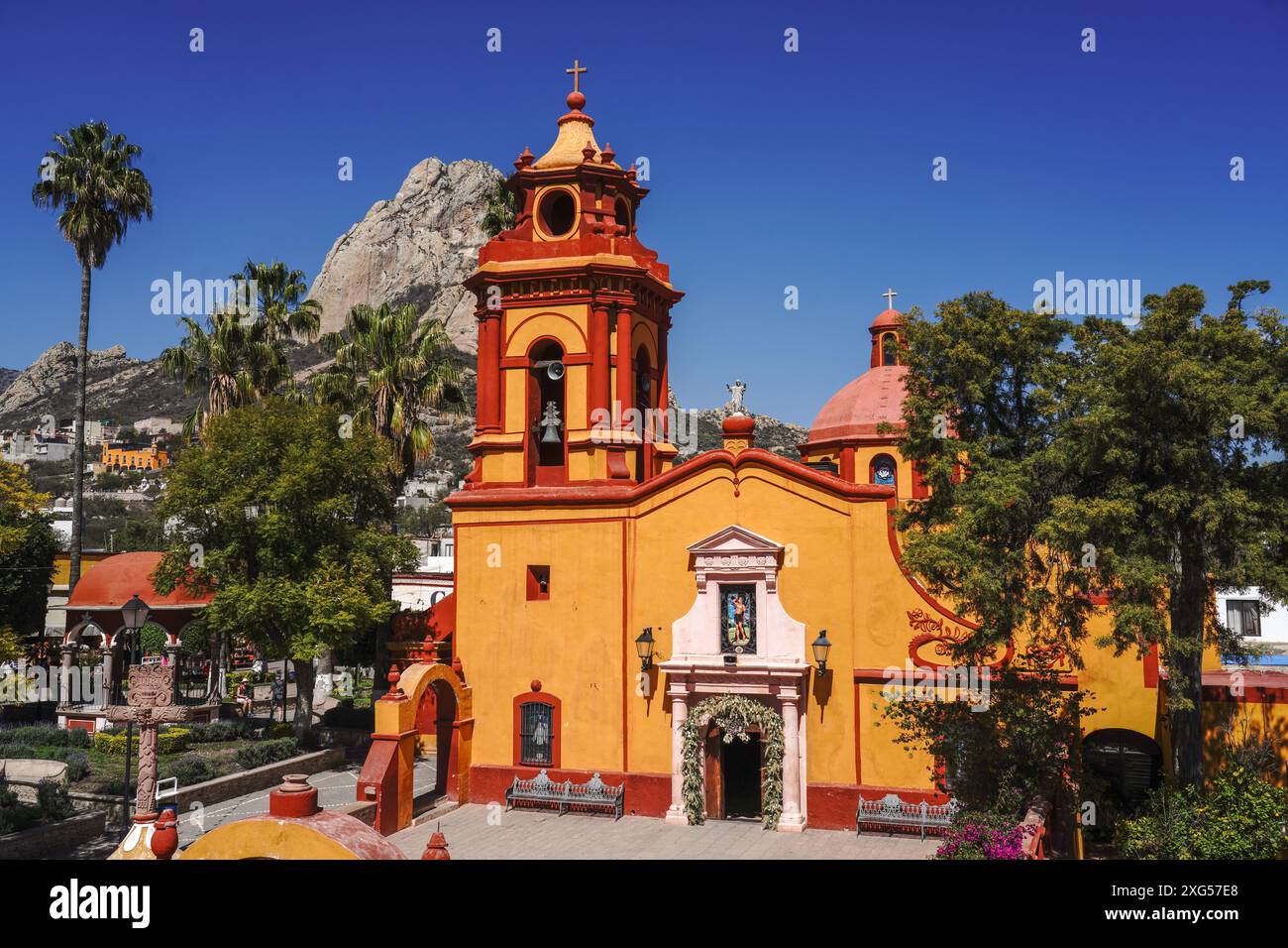 The Parroquia San Sebastian church with the massive Pena de Bernal rock ...