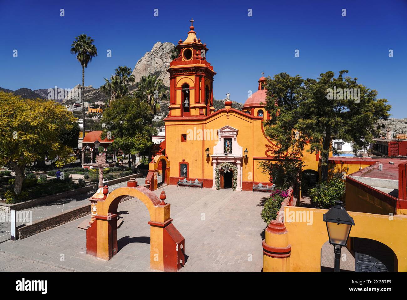 The Parroquia San Sebastian church with the massive Pena de Bernal rock ...
