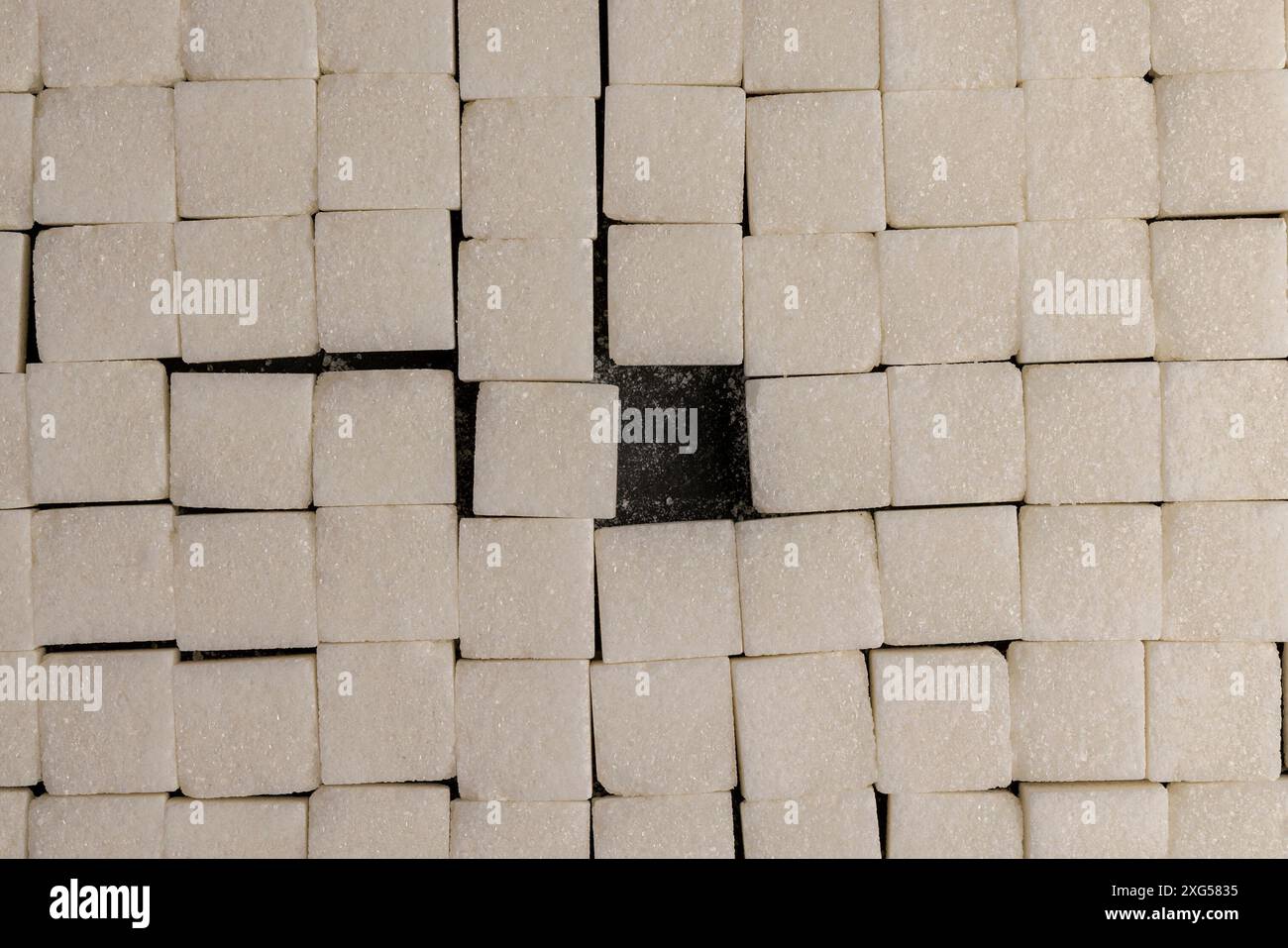 white square sugar on a black background , lump sugar in the shape of a ...