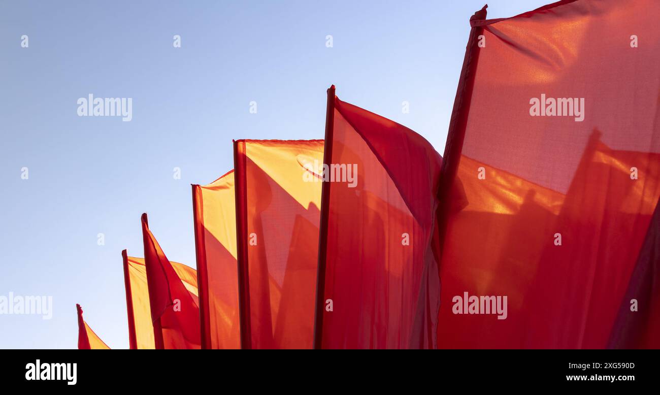 red flags set up during the celebration in windy weather, flags flutter ...