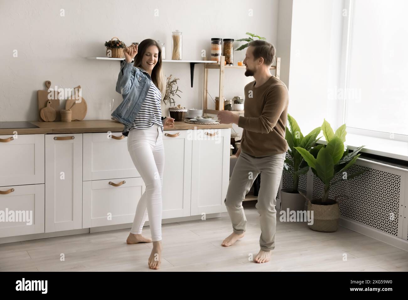 Woman dancing in light kitchen hi-res stock photography and images - Alamy