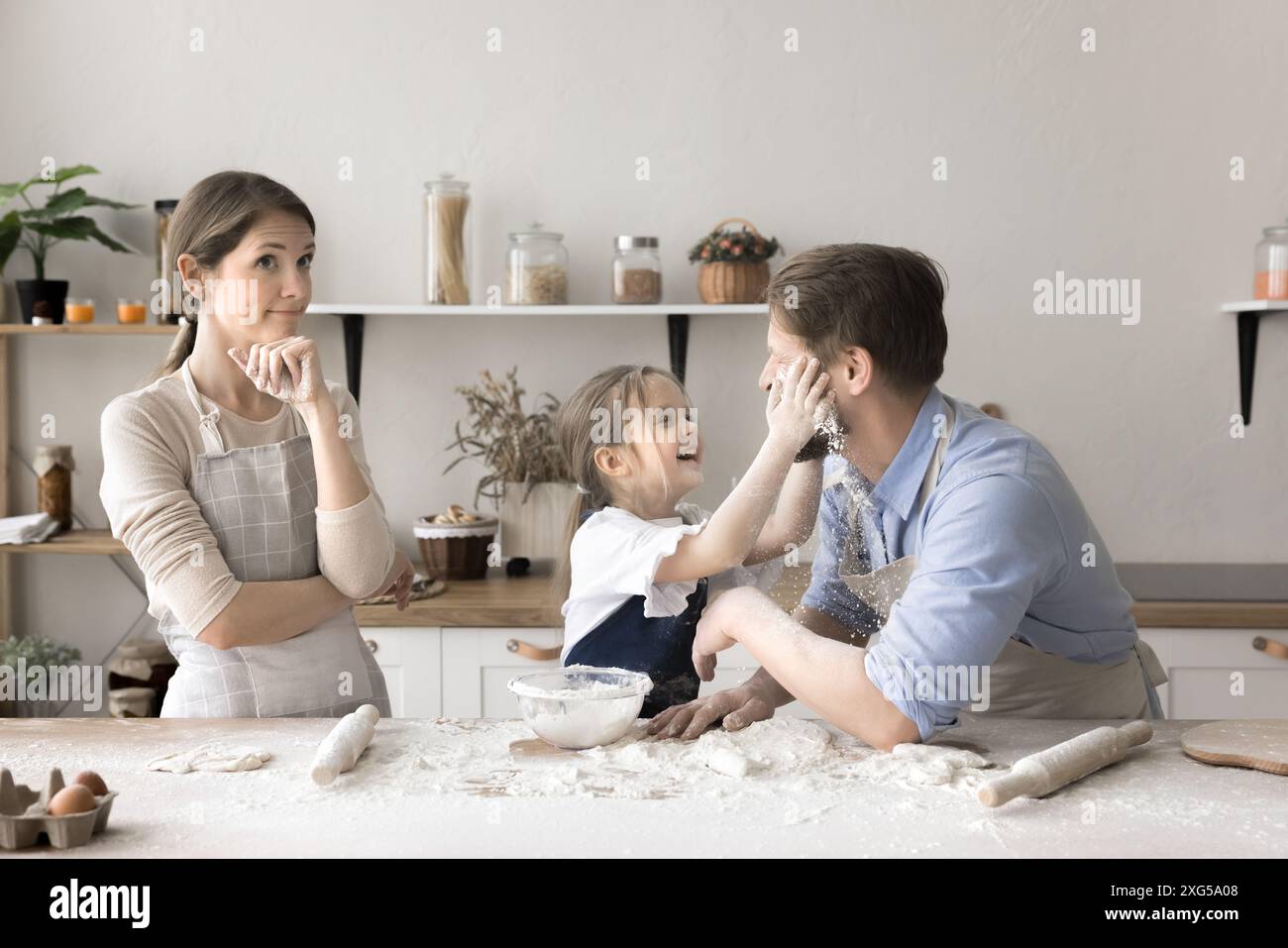 Family fooling, having fun cooking in the kitchen Stock Photo - Alamy